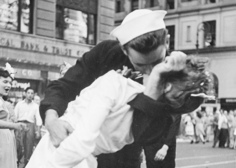 sailor kissing woman | Military Spouse